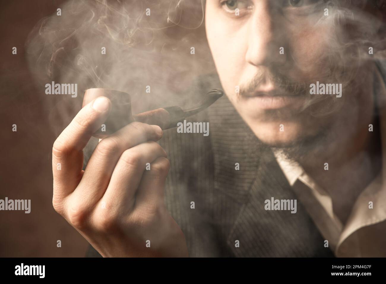 A man smokes a pipe and reads a newspaper. Retro style Stock Photo - Alamy