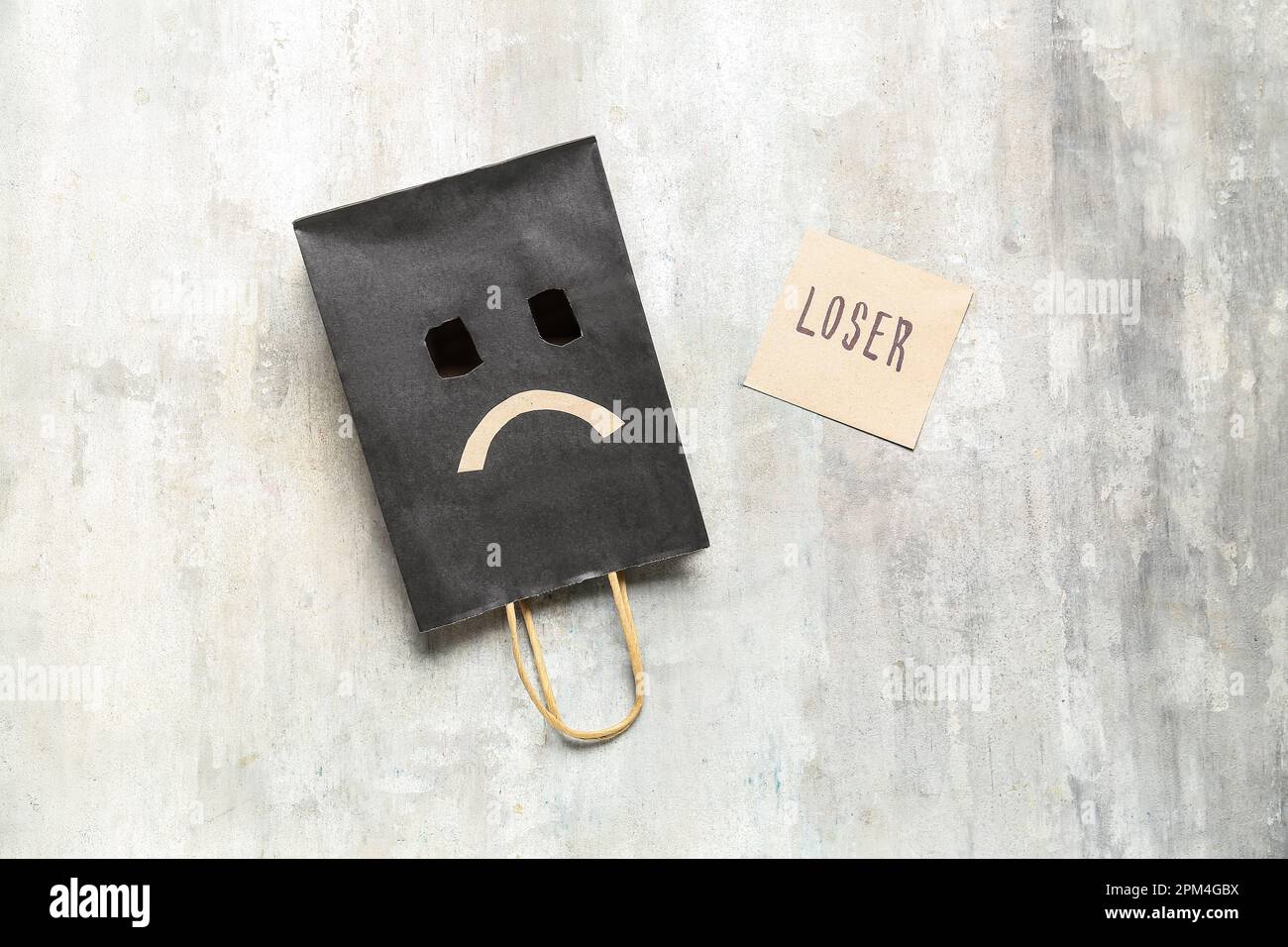Paper bag with sad smile and word LOSER on grunge background Stock Photo - Alamy