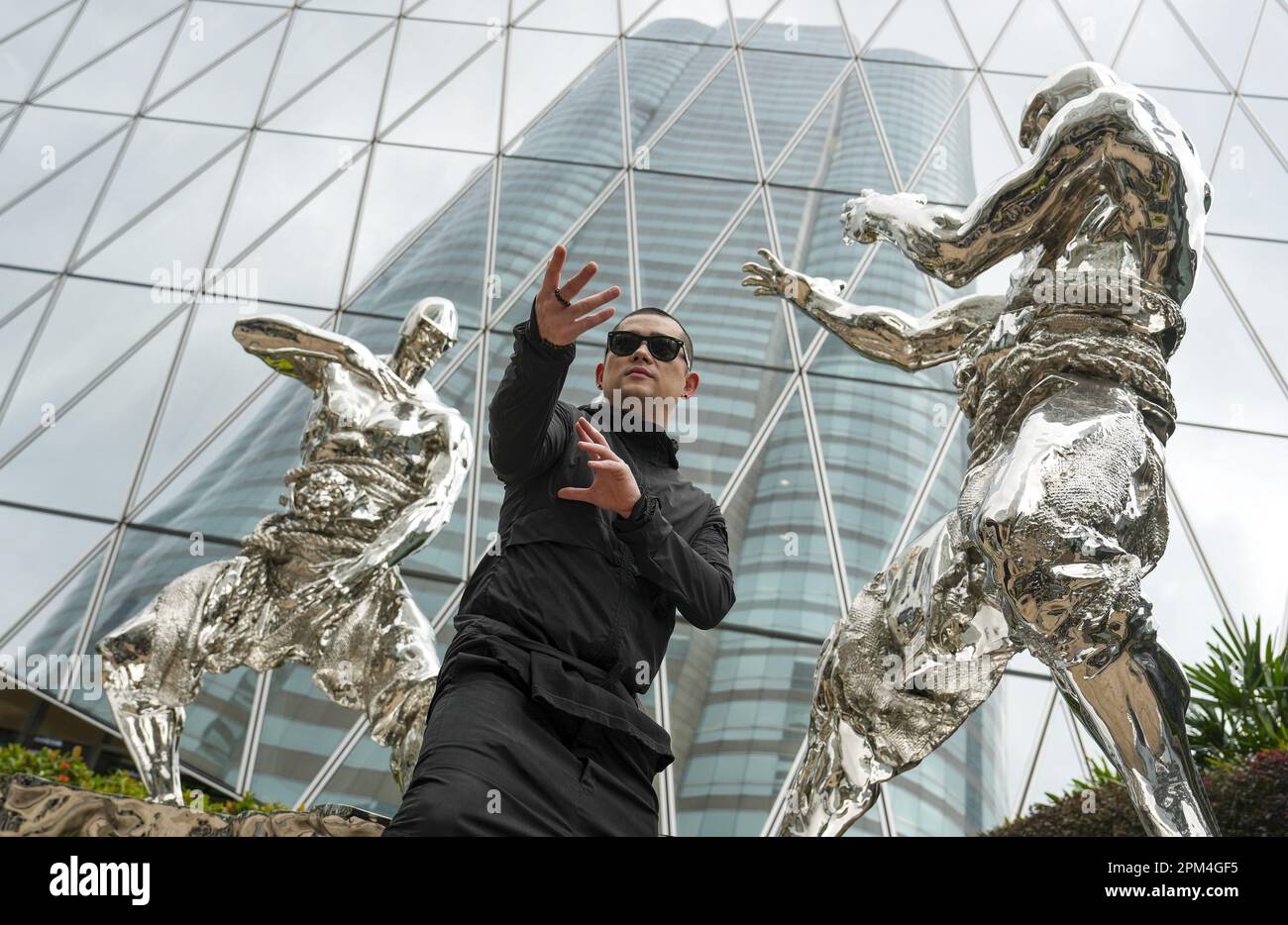 Sculptor Ren Zhe, poses in front of his work HHbove the Clouds" at the ...