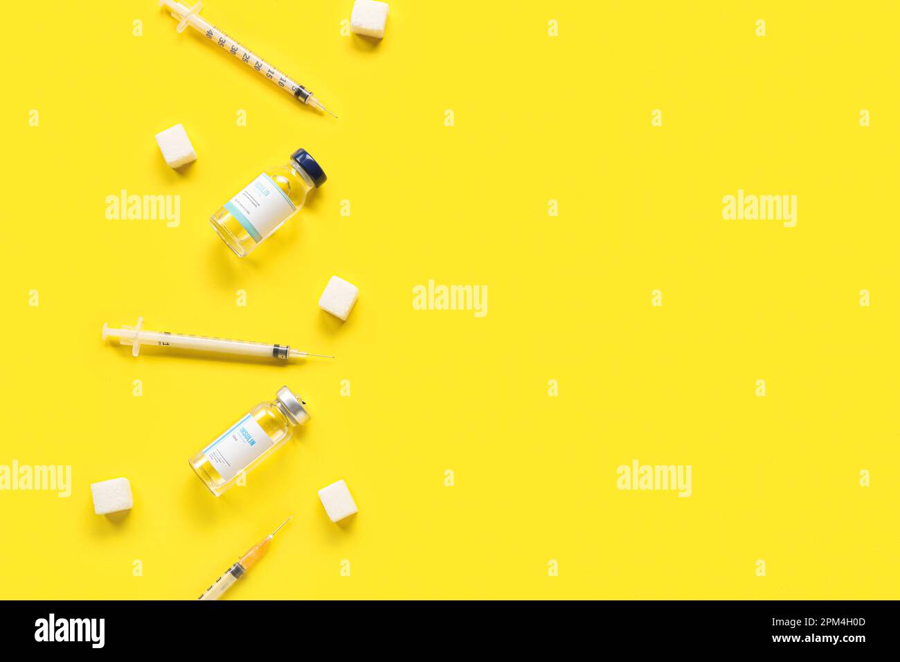 Insulin with syringes and sugar on yellow background. Diabetes concept ...