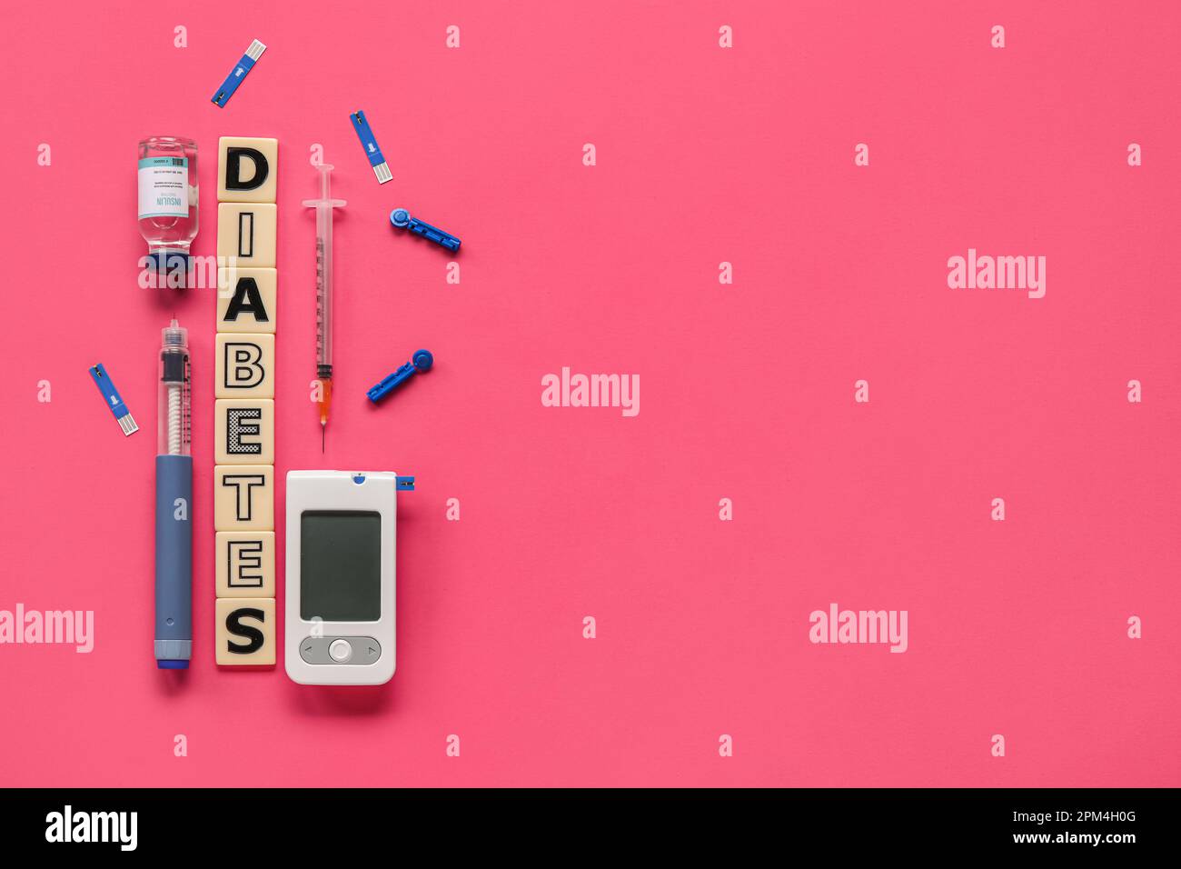 Word DIABETES with insulin, glucometer and lancet pen on pink ...