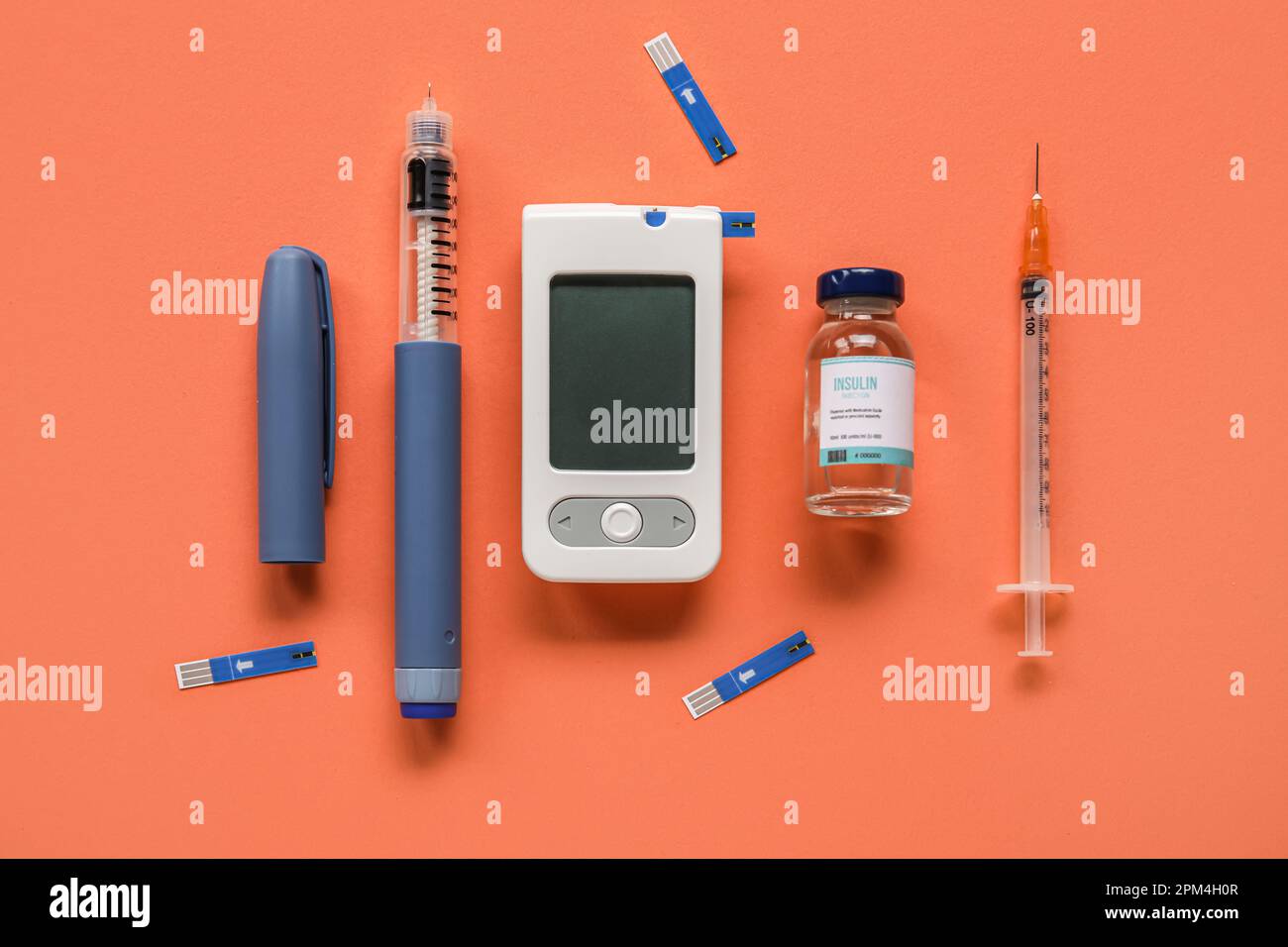 Glucometer with lancet pen and insulin on red background. Diabetes ...