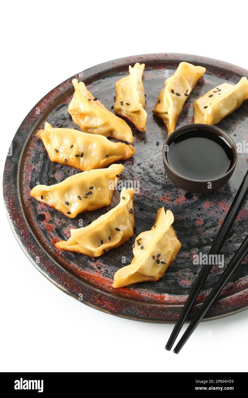 Plate with tasty Chinese jiaozi and sauce on white background Stock Photo - Alamy