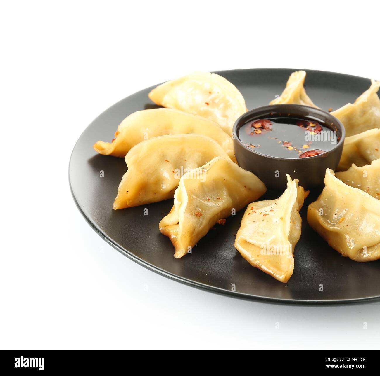 Plate with tasty Chinese jiaozi and sauce on white background Stock Photo - Alamy