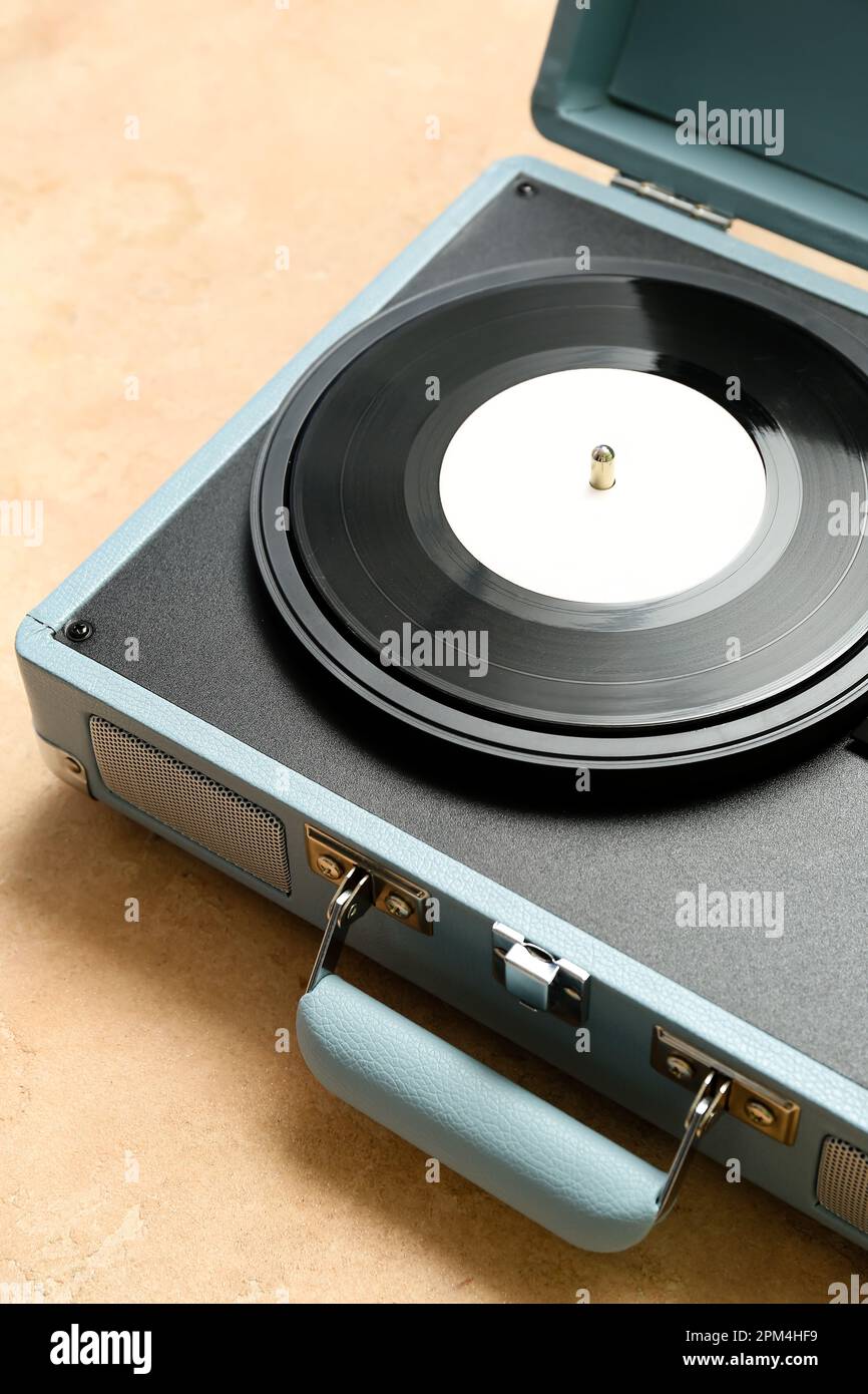 Record player with vinyl disk on beige background, closeup Stock Photo ...