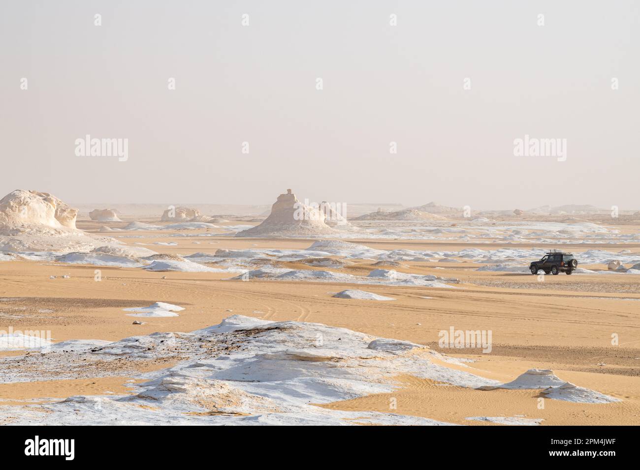 A jeep driving through the white desert in Bahariya in Egypt Stock ...