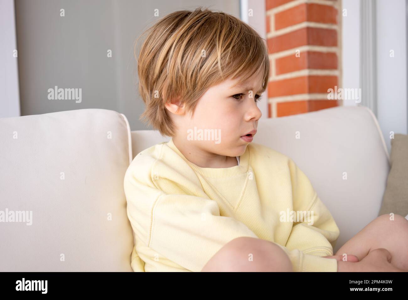 Sad child boy portrait sitting in the terrace at home Stock Photo - Alamy