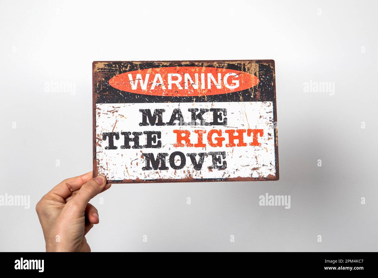 Make The Right Move. Warning sign with text in the hands of a woman ...