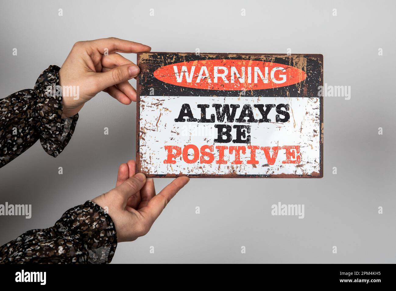 Always Be Positive Concept. Warning sign with text in the hands of a ...