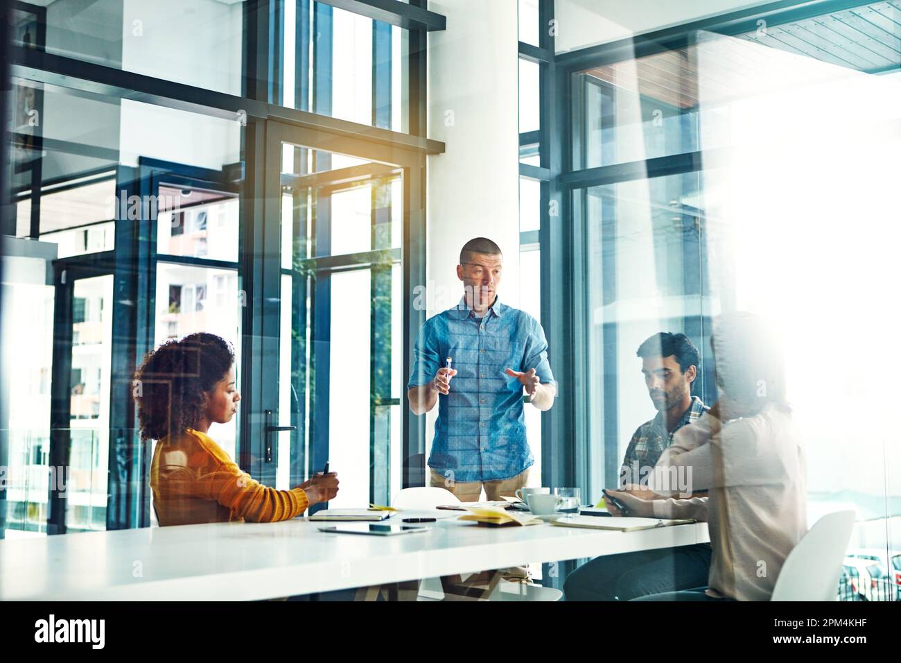 Going through the plan step by step. a young businessman giving a ...