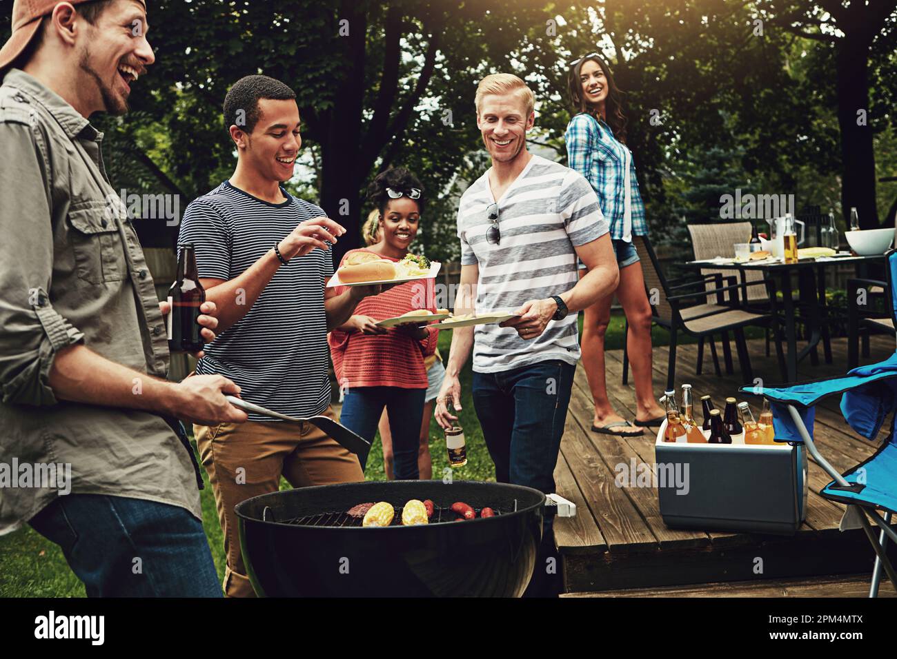 Weekends are all about grilling and chilling. a group of friends having ...