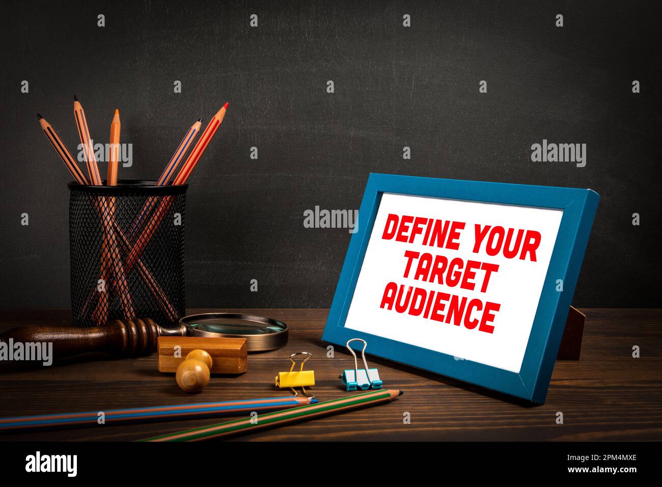 Define Your Target Audience. Picture frame with text. Wooden office ...