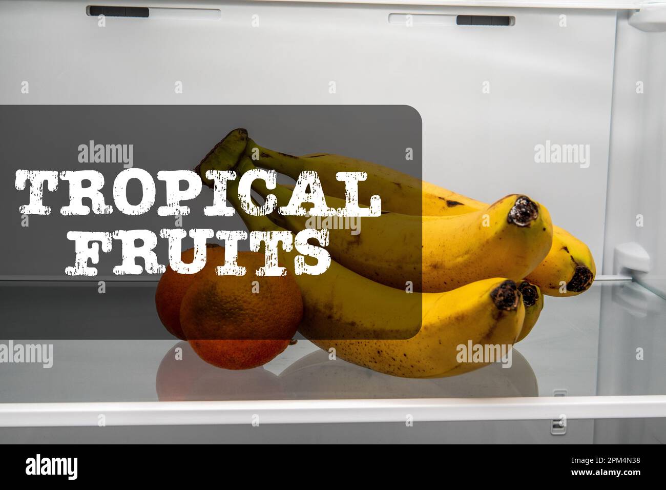 Tropical Fruits. Bananas and oranges in the fridge Stock Photo - Alamy