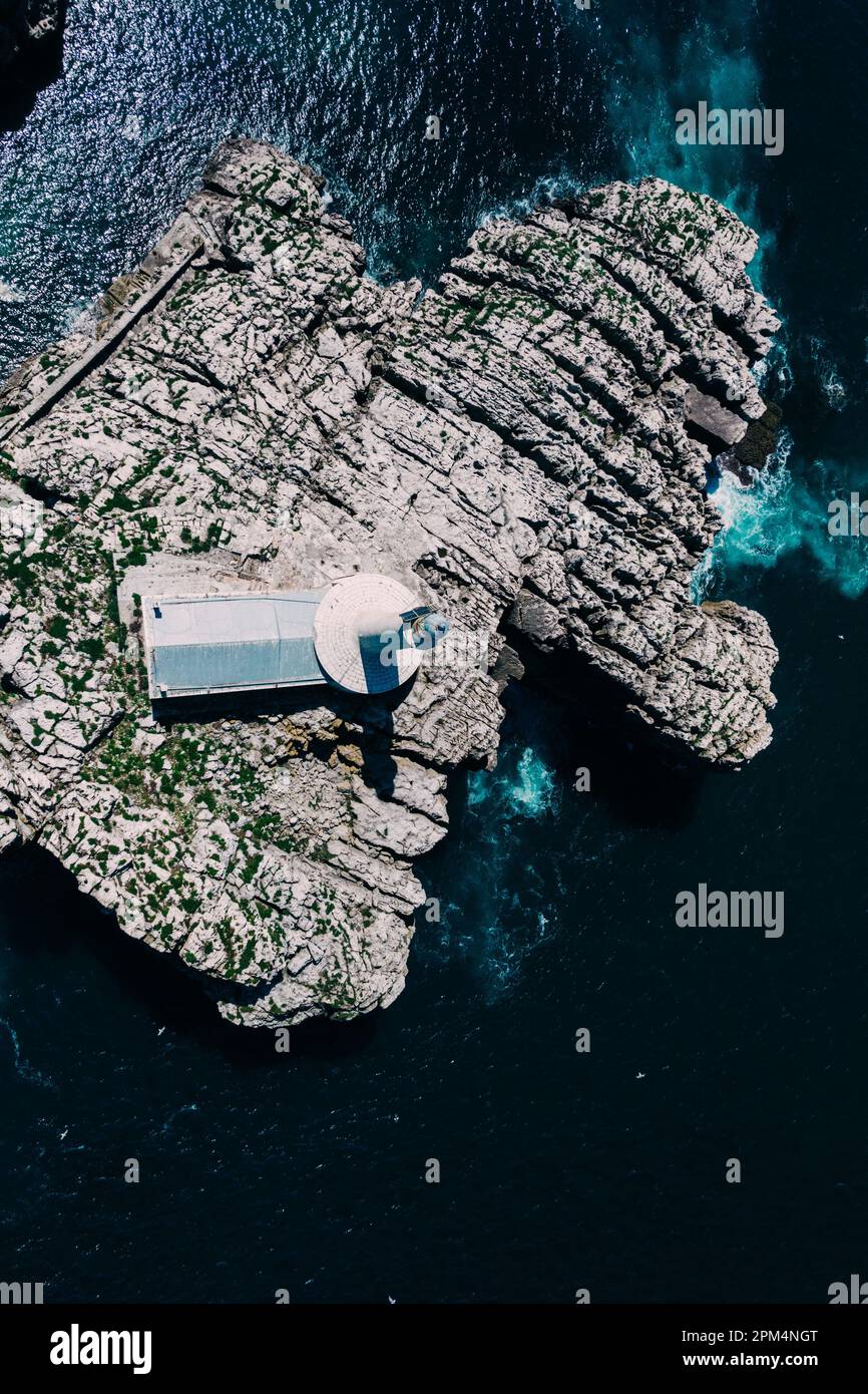 Aerial top down view of lighthouse and Island of Mouro at the entrance ...