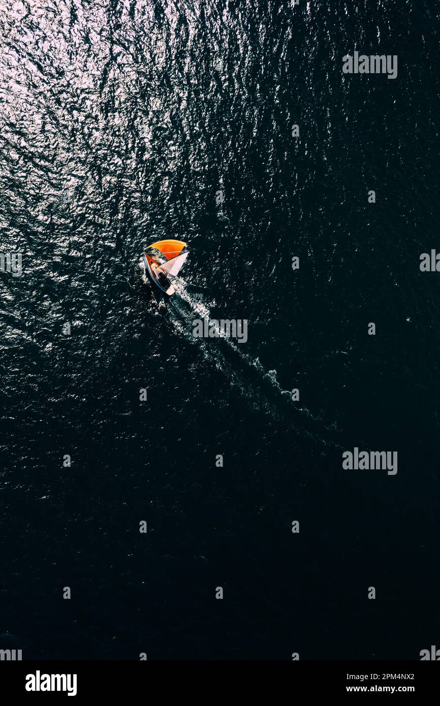 Top down aerial view of orange sailboat in water Stock Photo - Alamy