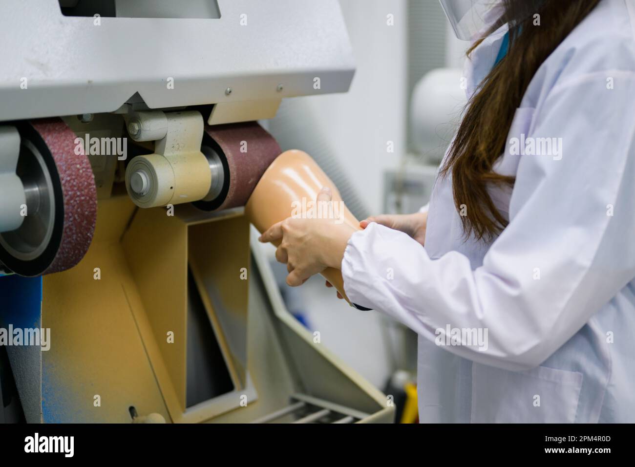 Technician making prosthetic limb using grinder to smooth socket Stock ...