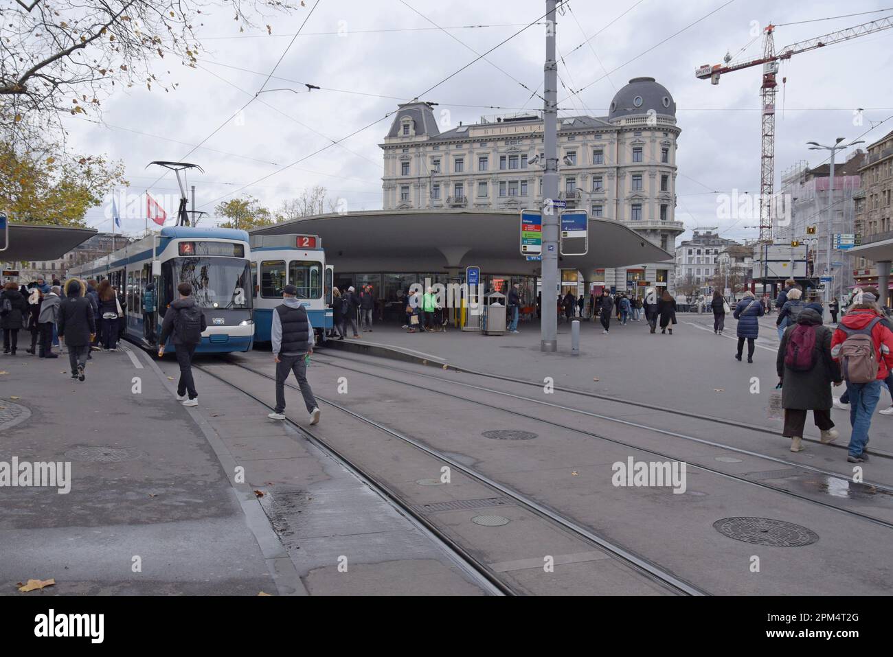 Passengers catching trams at the Bellevue tram stop, Zurich ...