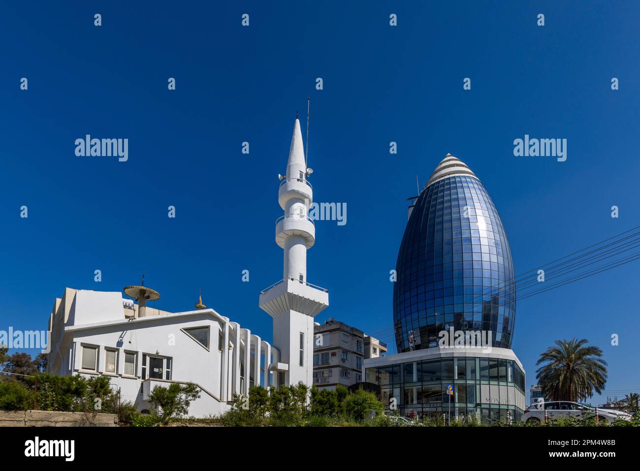 Mosque next to a modern building in Nicosia. Lefkoşa Türk Belediyesi ...
