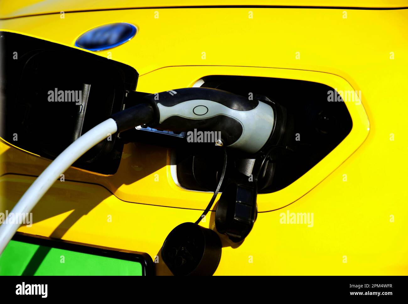 electric car charging station. yellow car detail with industrial grade ...
