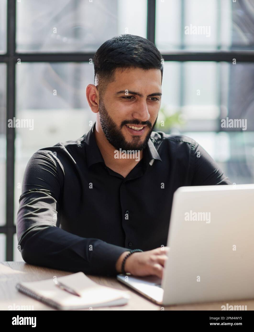 Bearded young businessman working on modern office. Consultant man ...