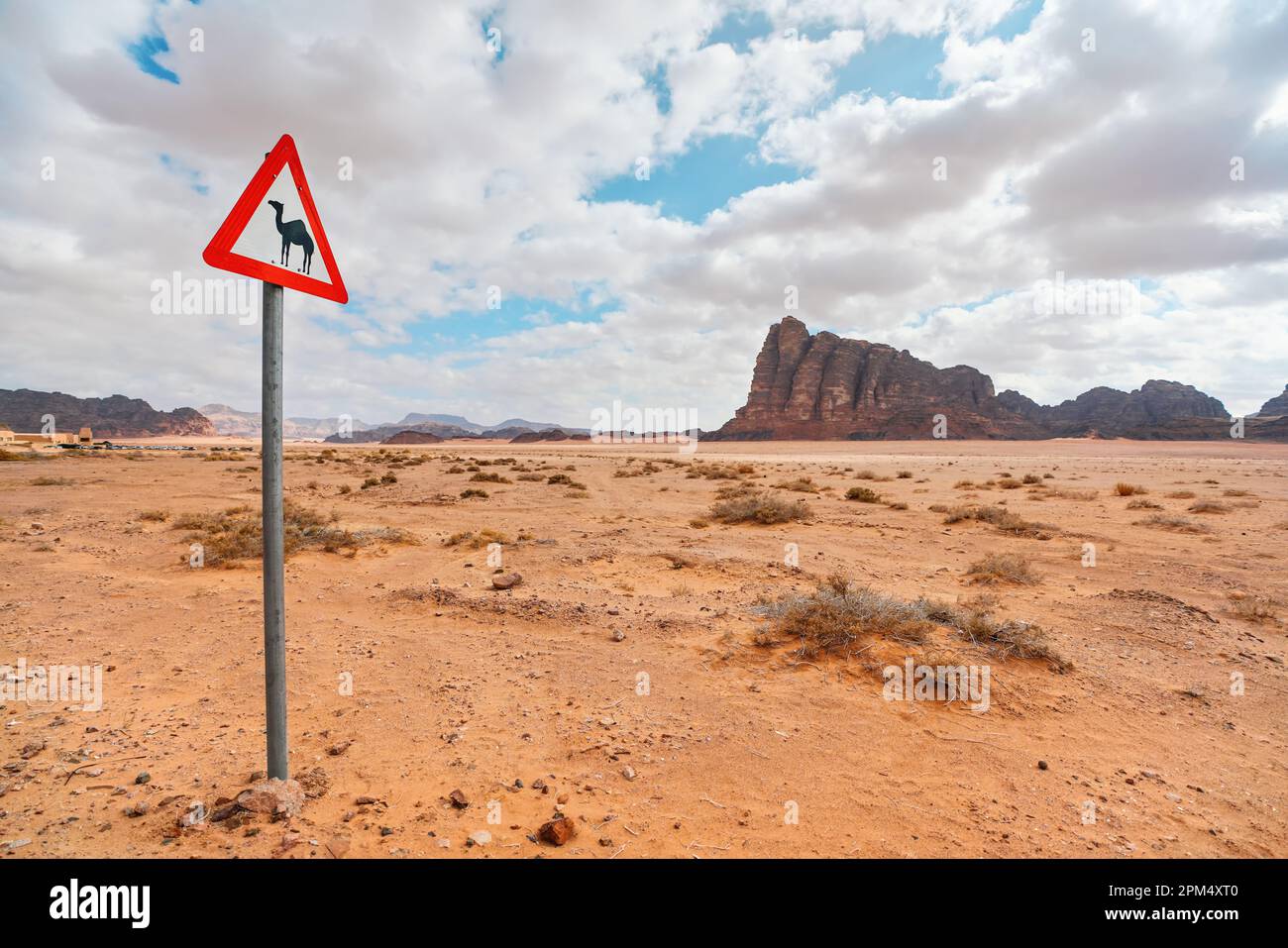 Desert landscape at Wadi Rum, red triangle warning camels sign near ...