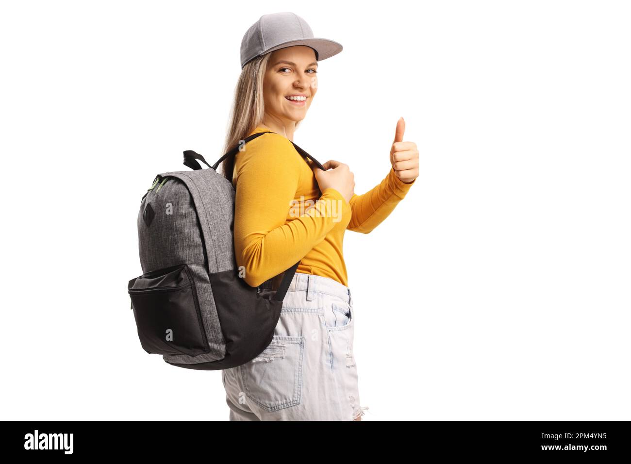 Female student with a backpack looking over shoulder and gesturing ...