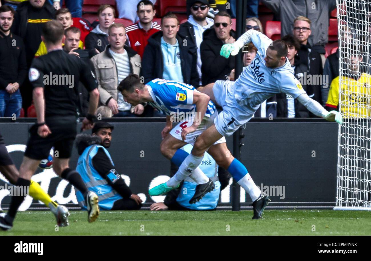 Watford goalkeeper Daniel Bachmann tackles Huddersfield Town's Matty ...