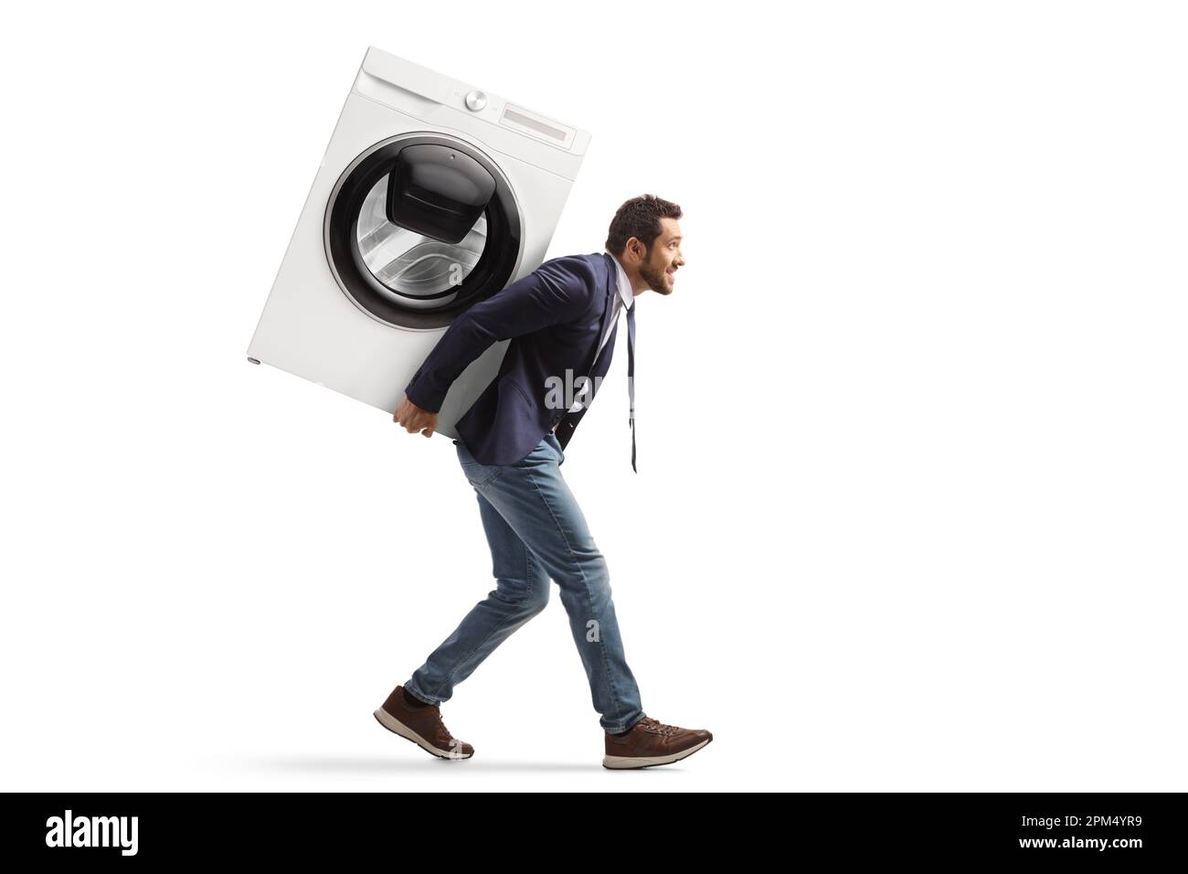 Full length profile shot of a man carrying a washing machine on his ...