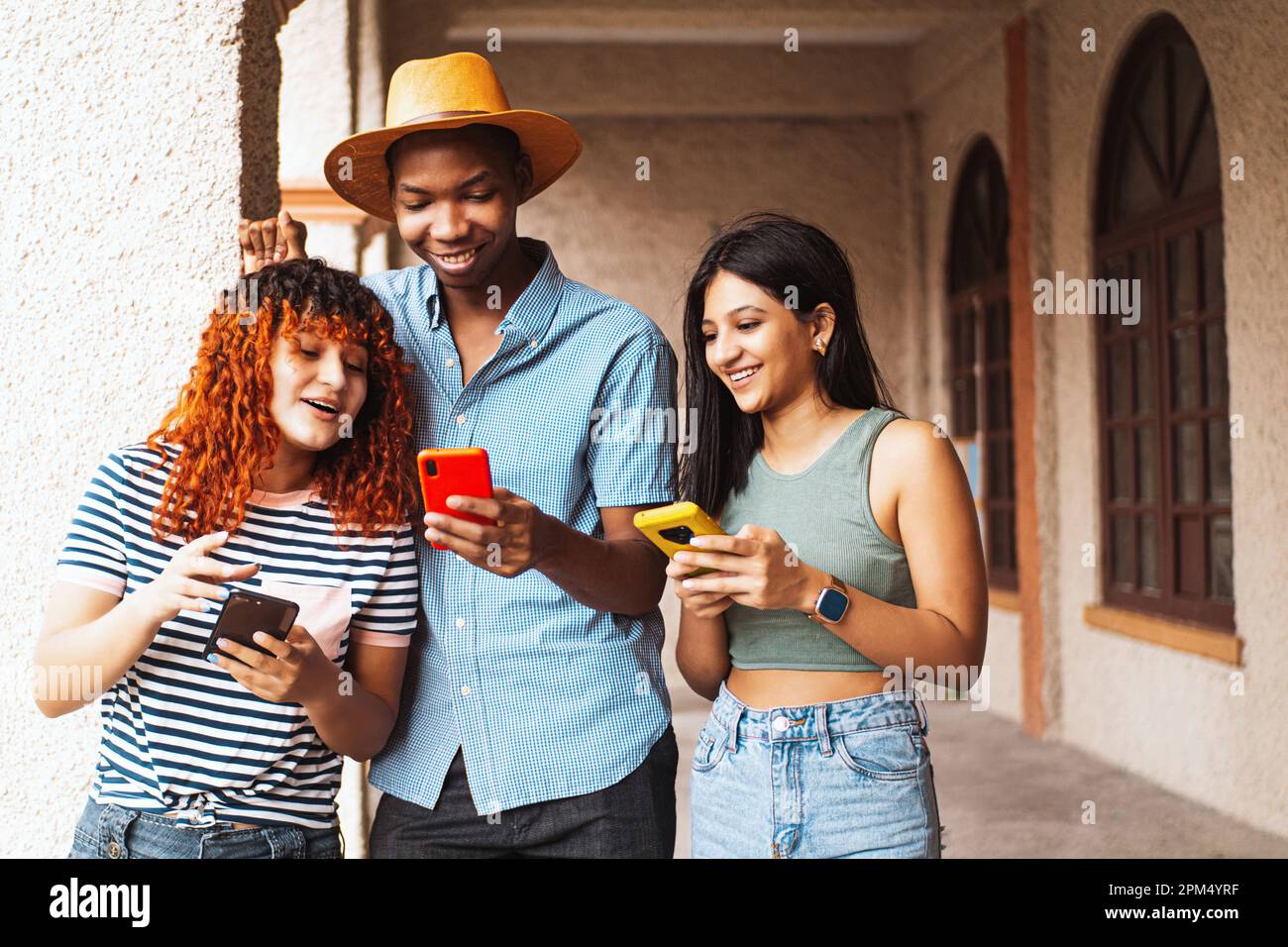 A group of young people using smartphones looking at social media ...