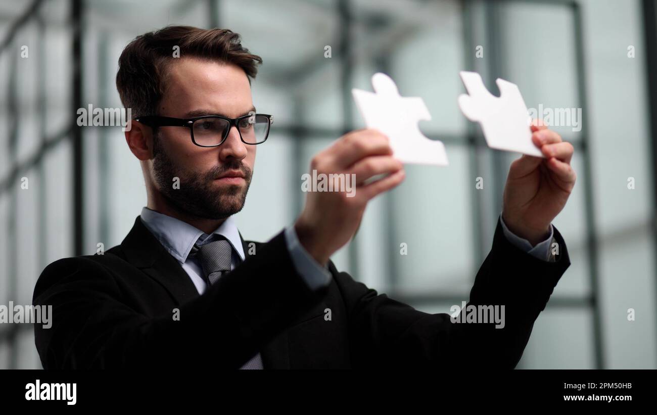 Business puzzle, strategy and marketing. Businessman shows silver ...
