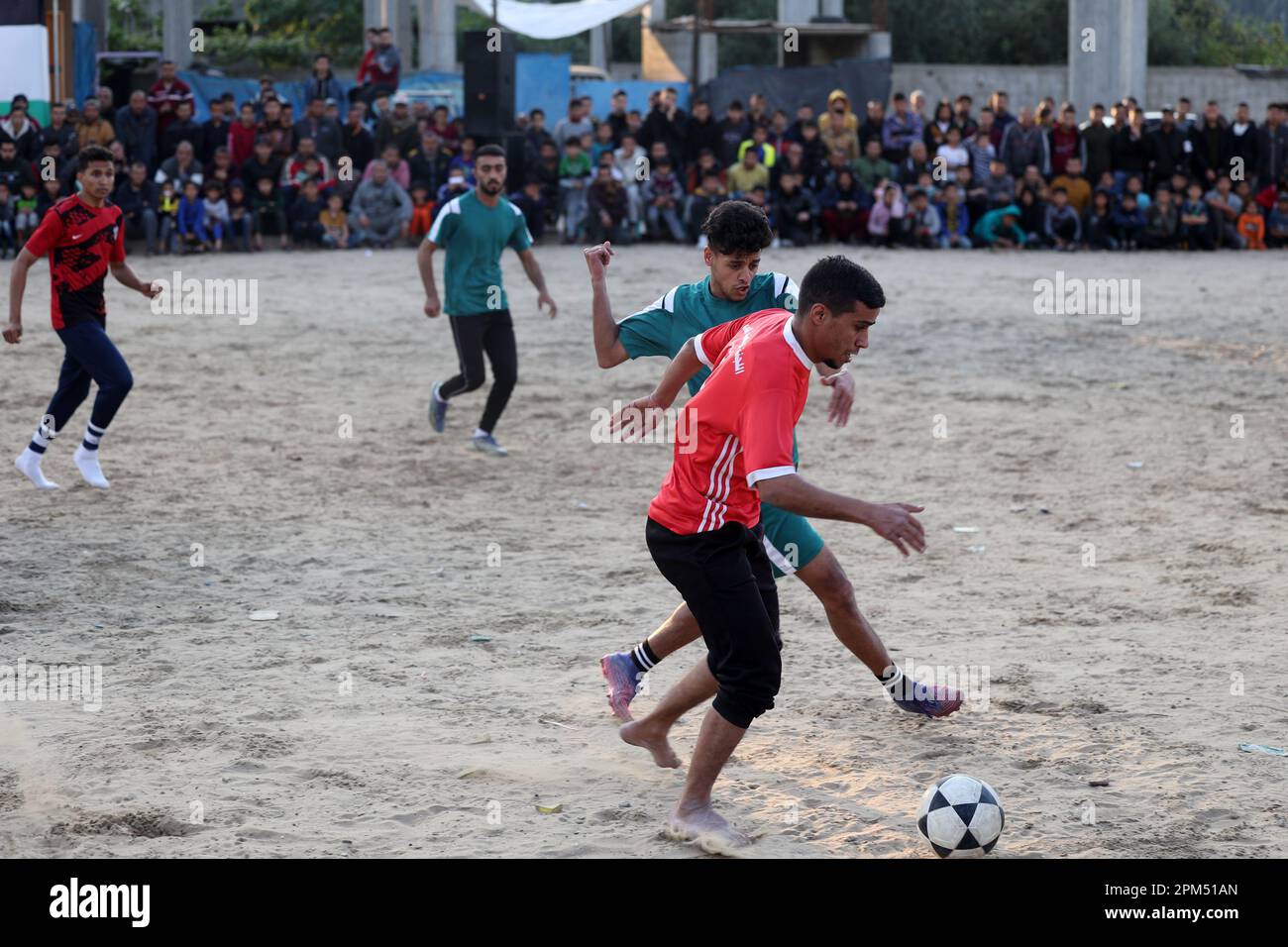 Young Palestinian men play football in Popular playgrounds, just before ...