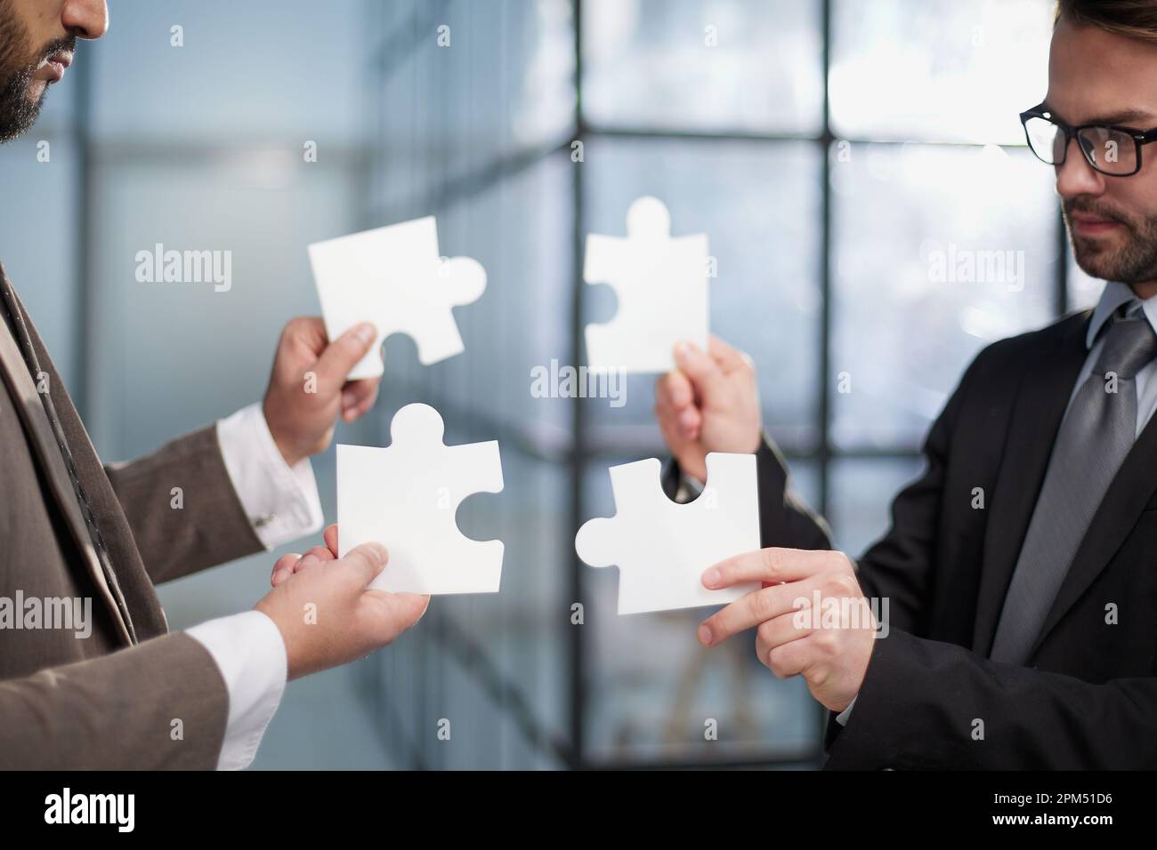 Working together to put things together. two unrecognizable ...