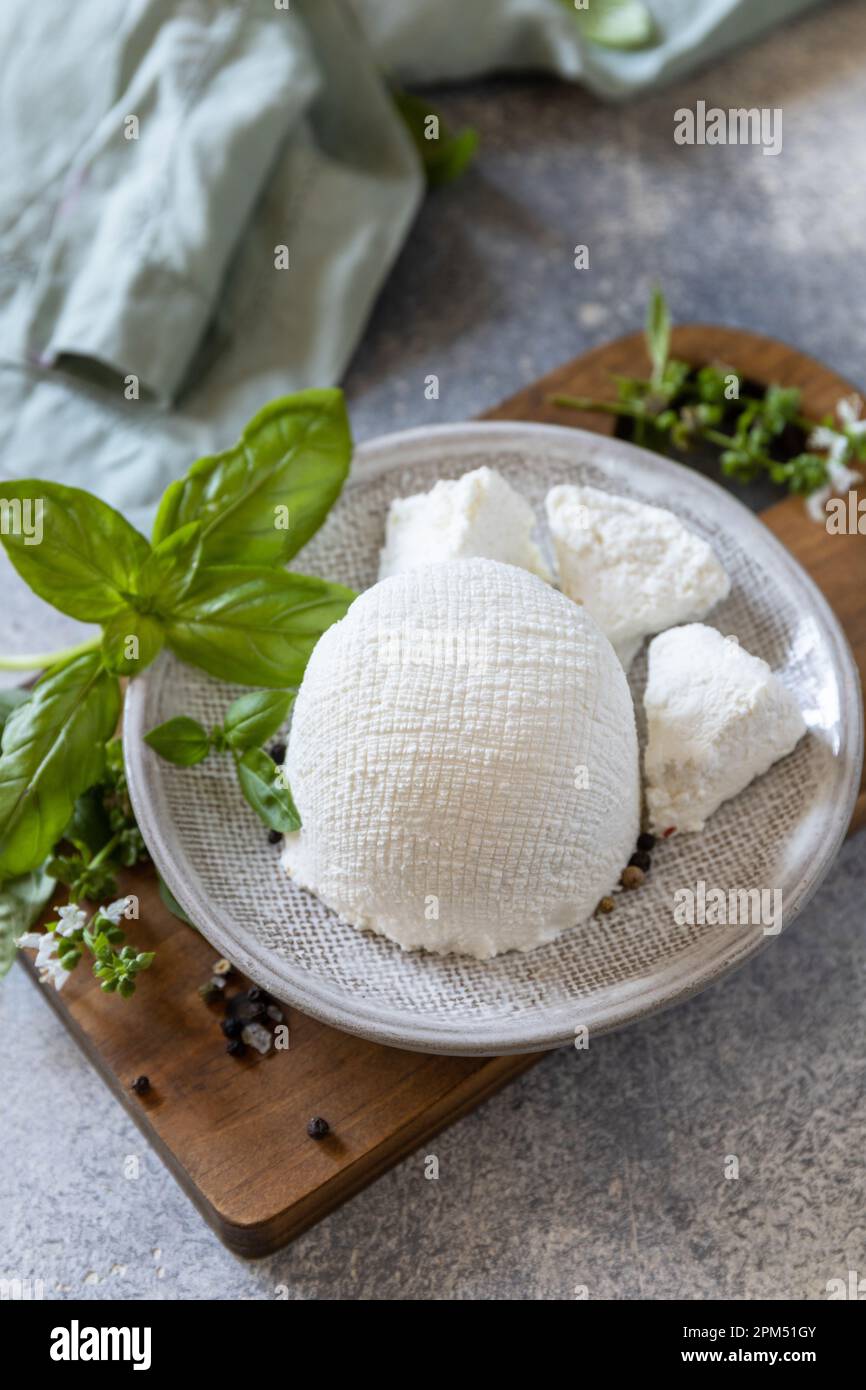 Homemade whey ricotta cheese or cottage cheese with basil ready to eat ...