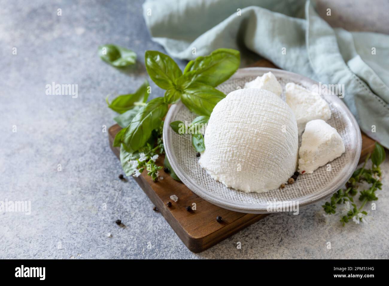 Homemade whey ricotta cheese or cottage cheese with basil ready to eat ...