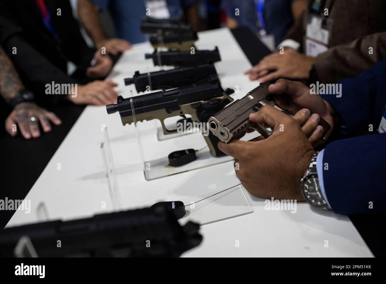A man handles a pistol displayed at the LAAD Defense and Security ...