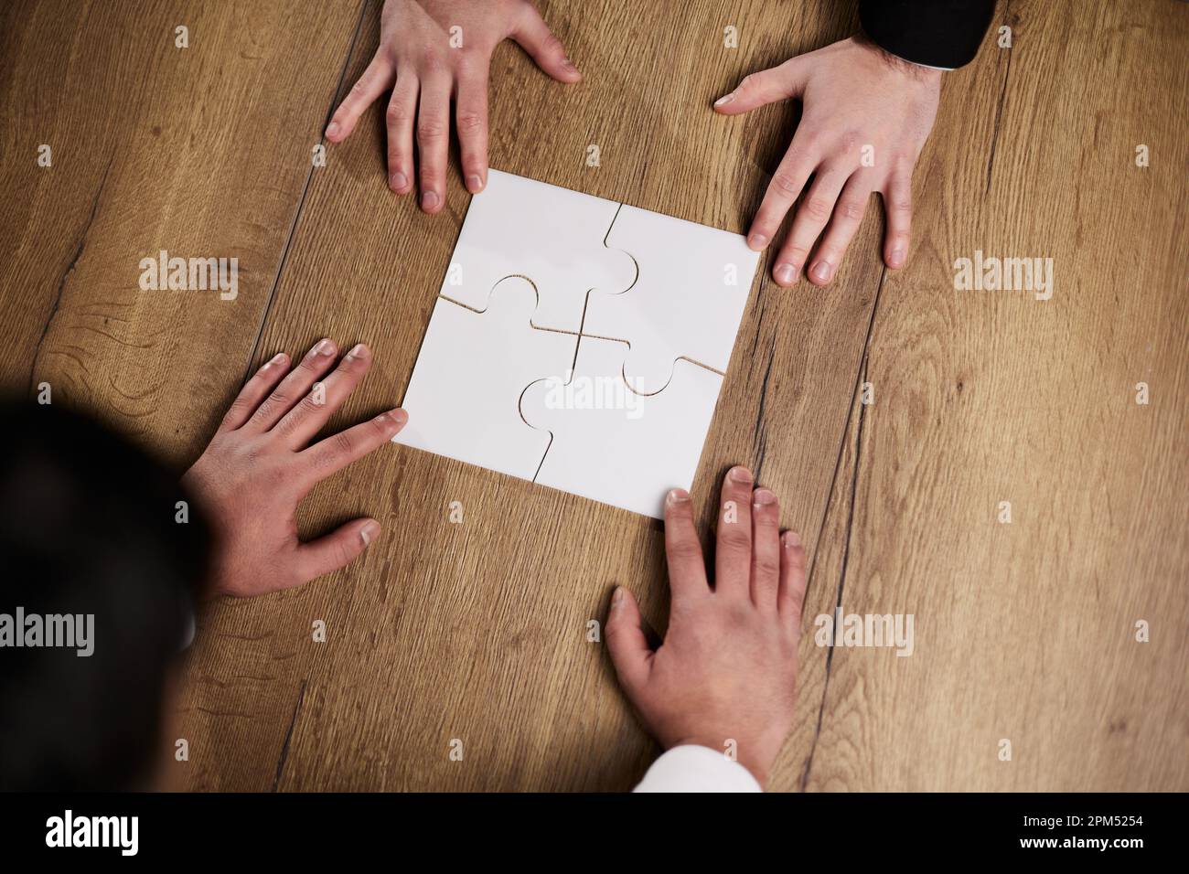 Above view of business team looking at paper during meeting and ...