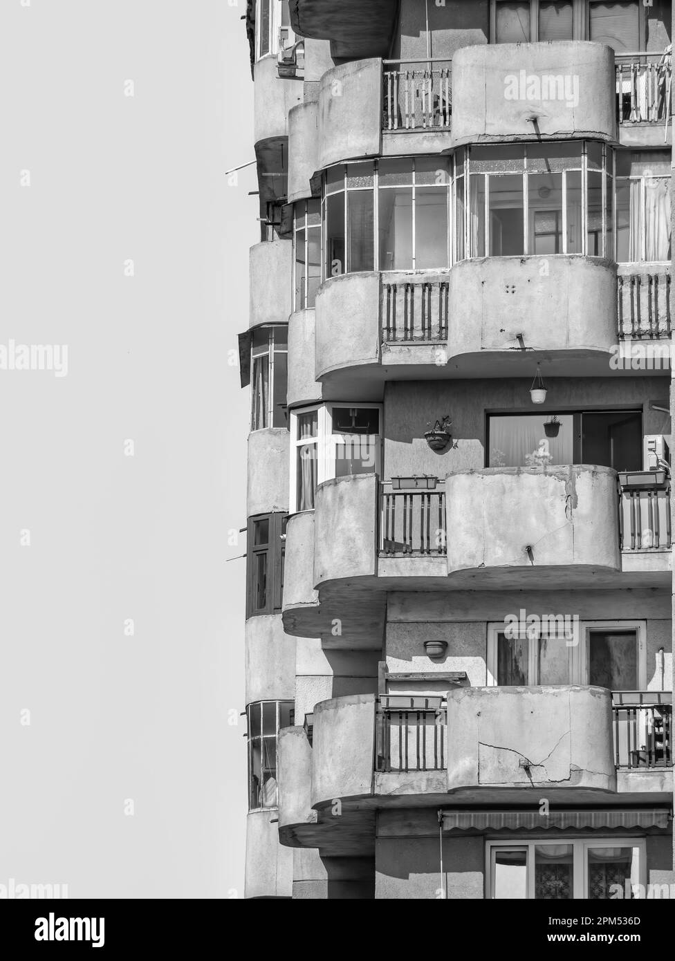 Worn out apartment building from the communist era against blue sky in ...