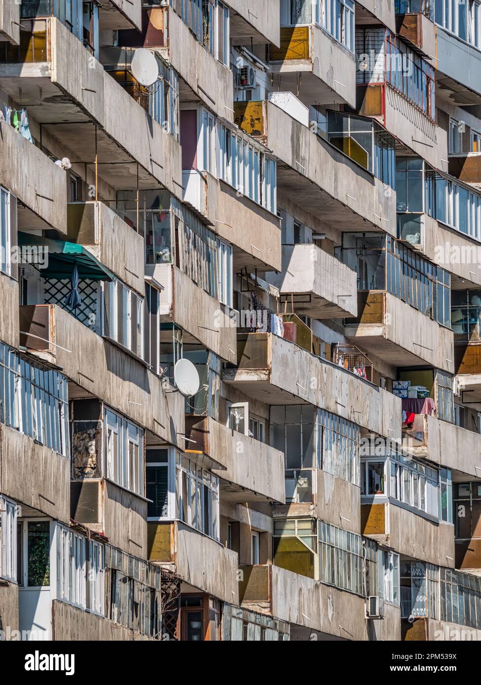 Worn out apartment building from the communist era against blue sky in ...