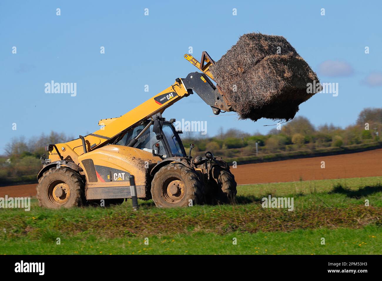 A Caterpillar telescopic handler TH337C travelling along the B1222 near ...