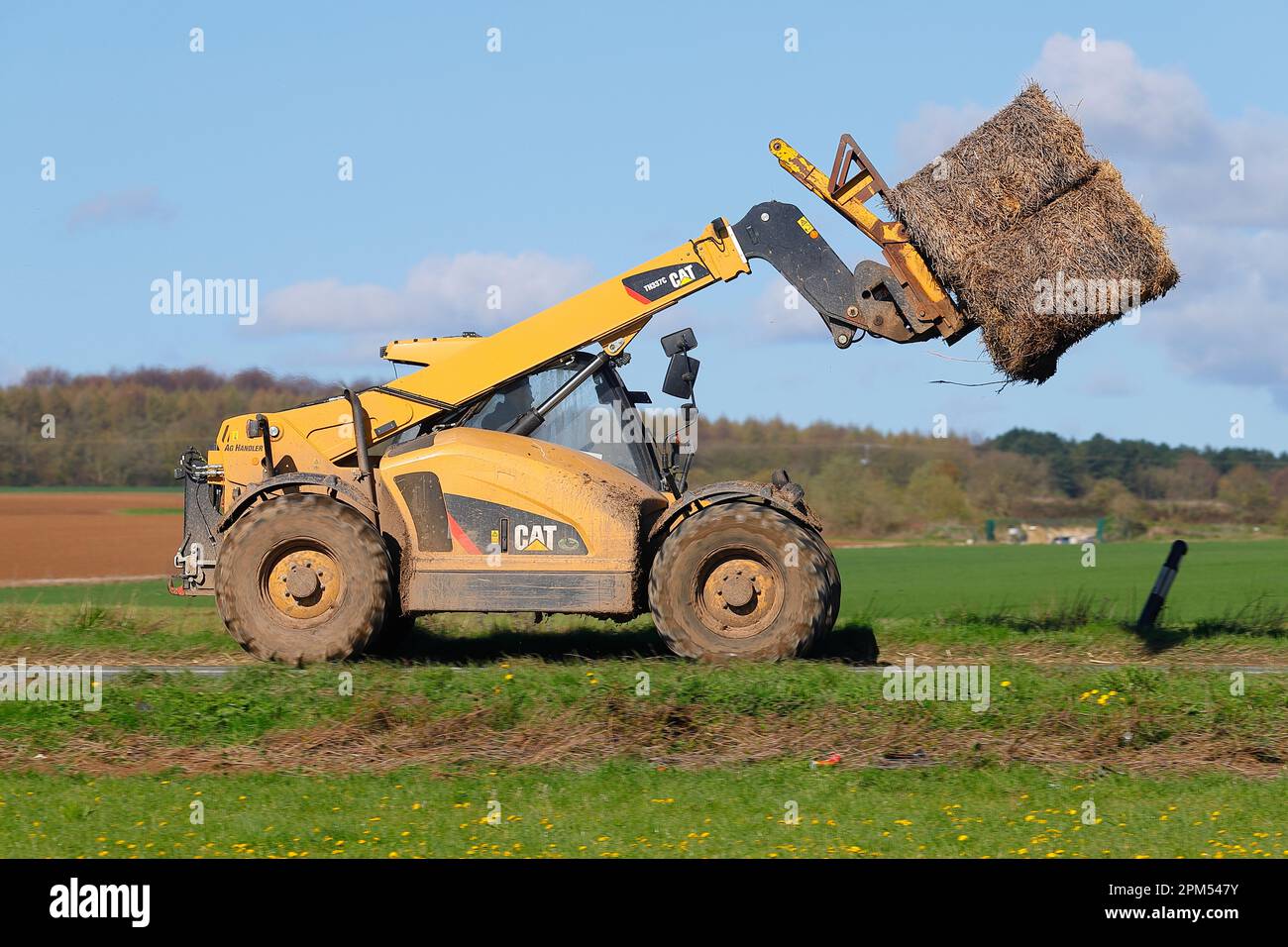 A Caterpillar telescopic handler TH337C travelling along the B1222 near ...