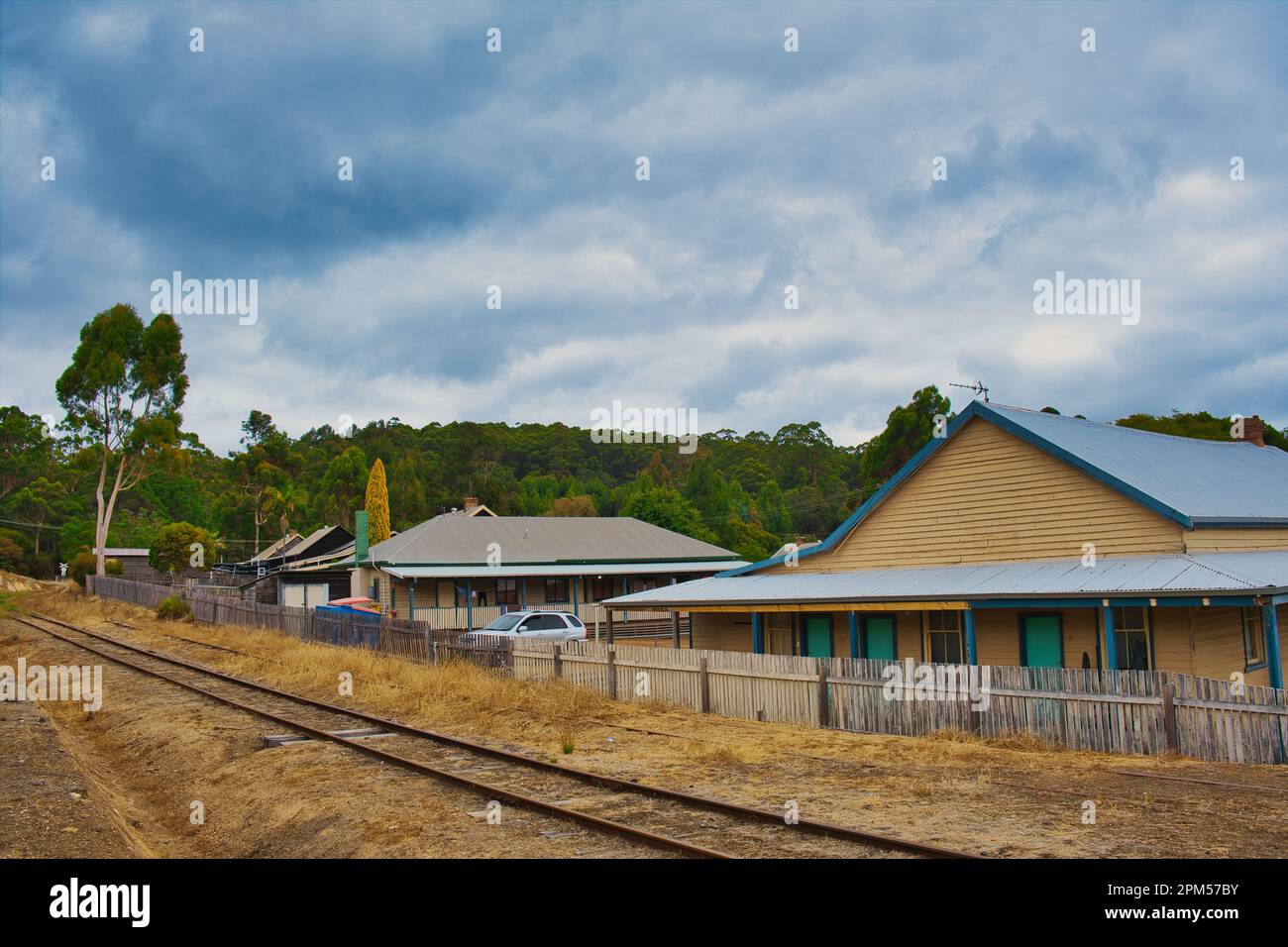 Old railroad along a row of traditional wooden houses in the Western ...