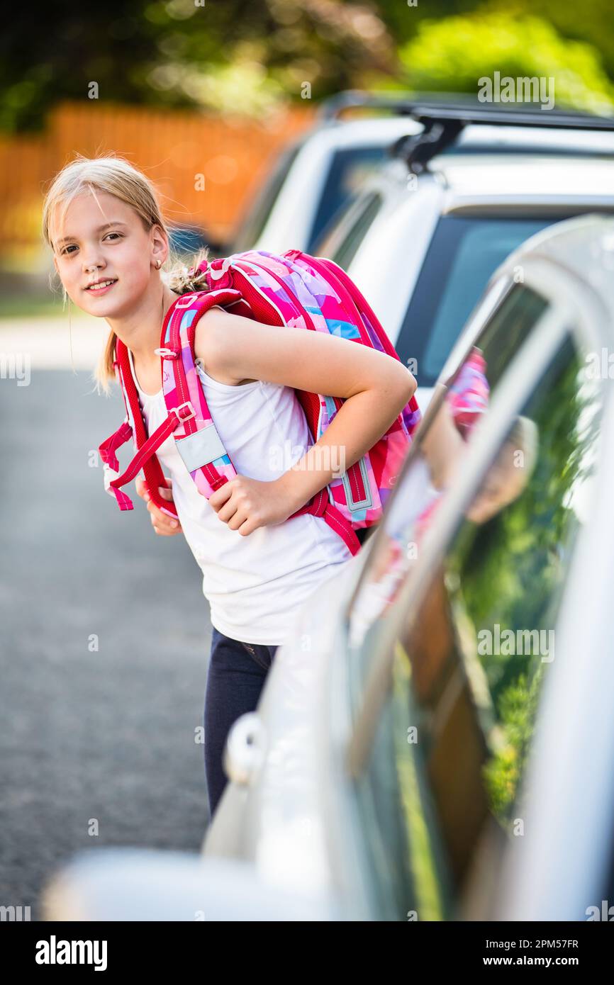 Cute little girl going home from school, looking well before crossing ...