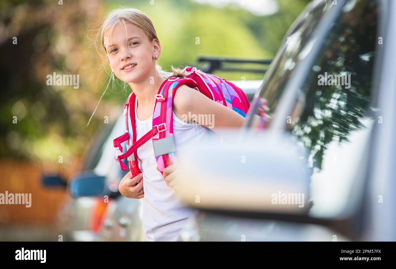 Cute little girl going home from school, looking well before crossing ...