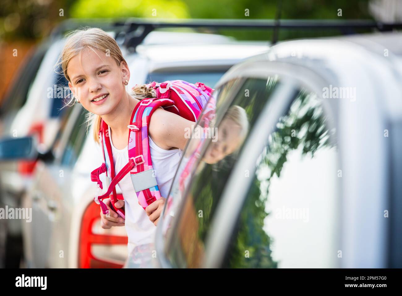 Cute little girl going home from school, looking well before crossing ...
