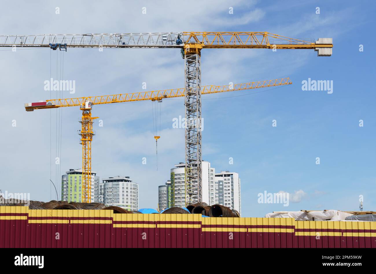 Construction cranes against the blue sky. Bottom view. Building concept ...