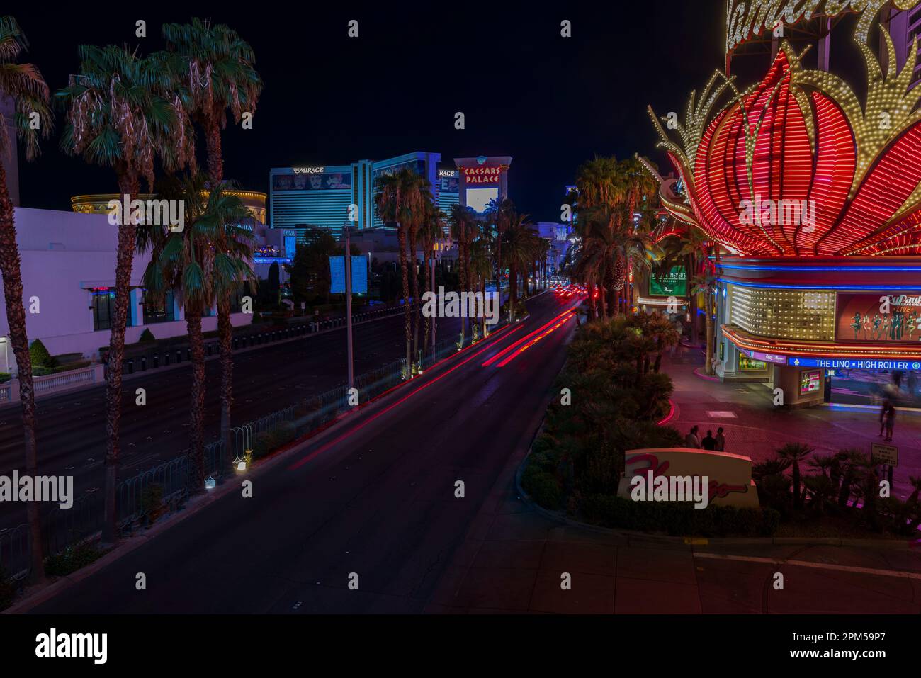 Night view of Las Vegas cityscape with defocused light tracers of cars on Strip Road. Las Vegas ...