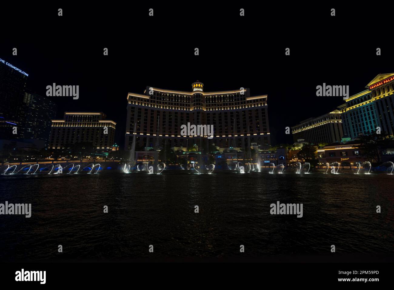 View of sights of Las Vegas at night on Strip overlooking fountains of ...