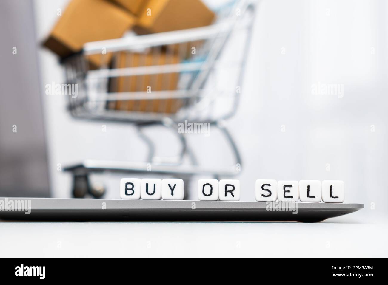 Buy yes or no words on cubes laying on the laptop and a toy shopping ...