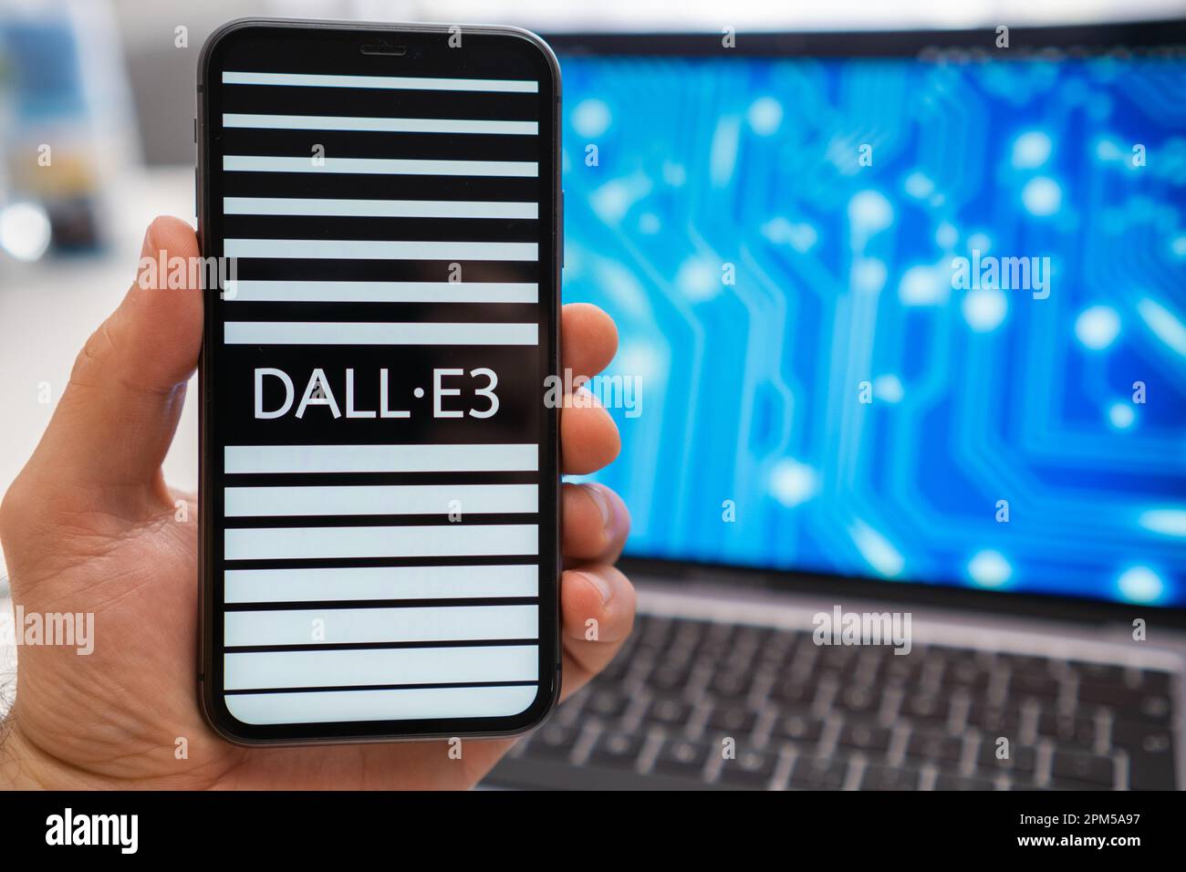 The screen of a smartphone held by a man shows DALL E3 neural network ...