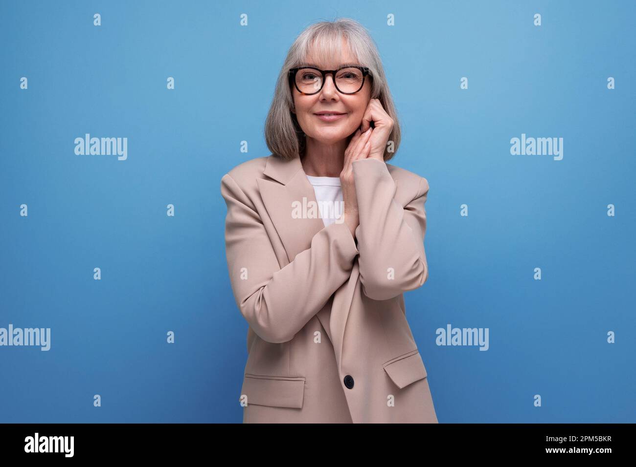 nice neat business 60s lady in a stylish look on a studio background ...